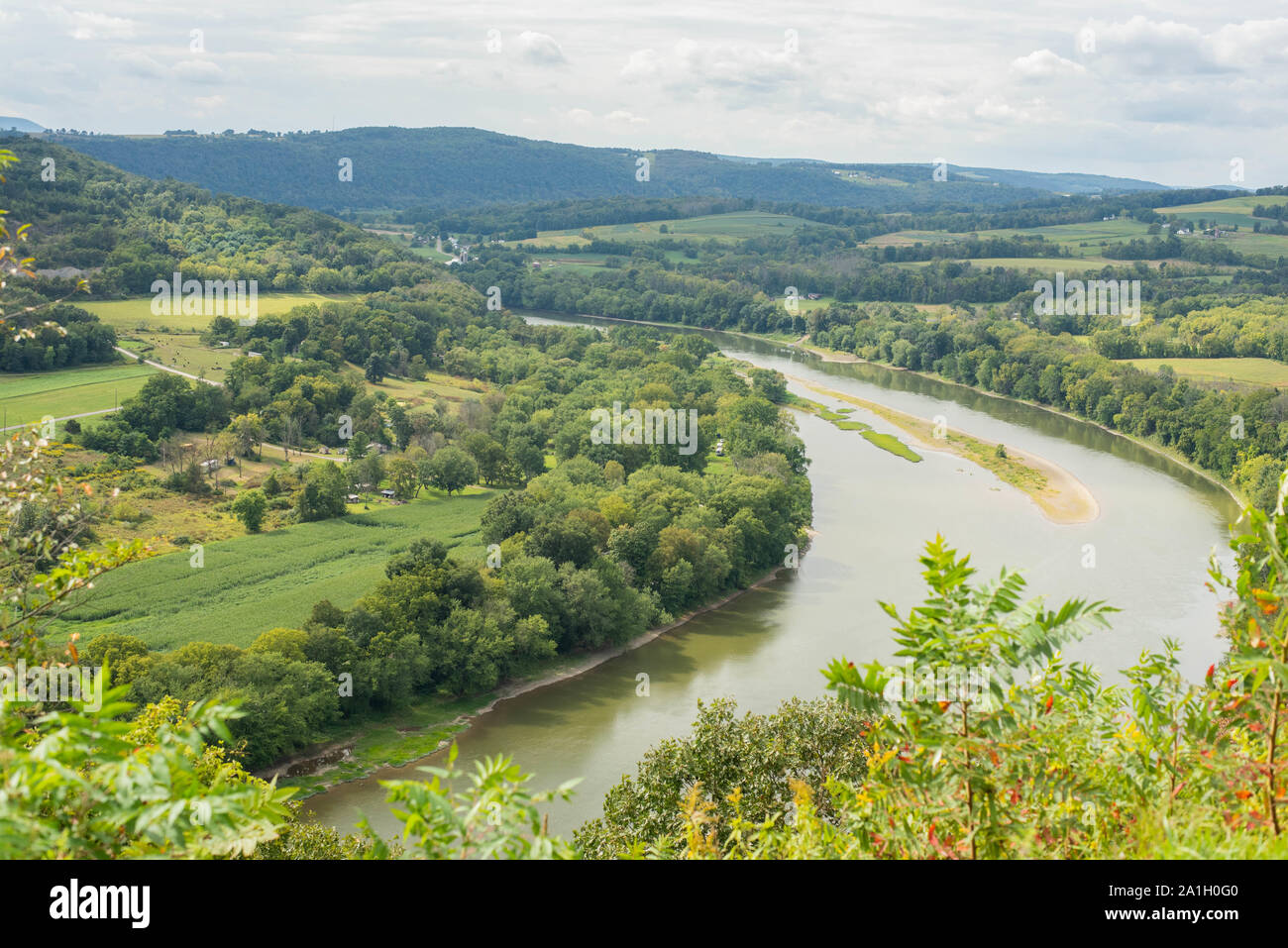 View of a river between farmland and rolling green hills in Wyalusing ...