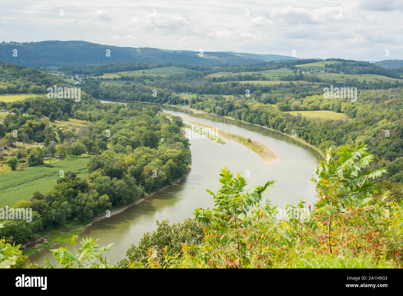 View of a river between farmland and rolling green hills in Wyalusing ...