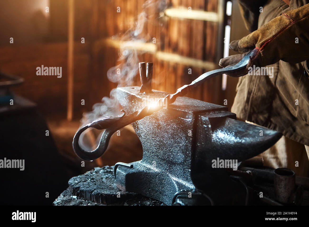 The hands of a blacksmith at work in the smithy Stock Photo - Alamy