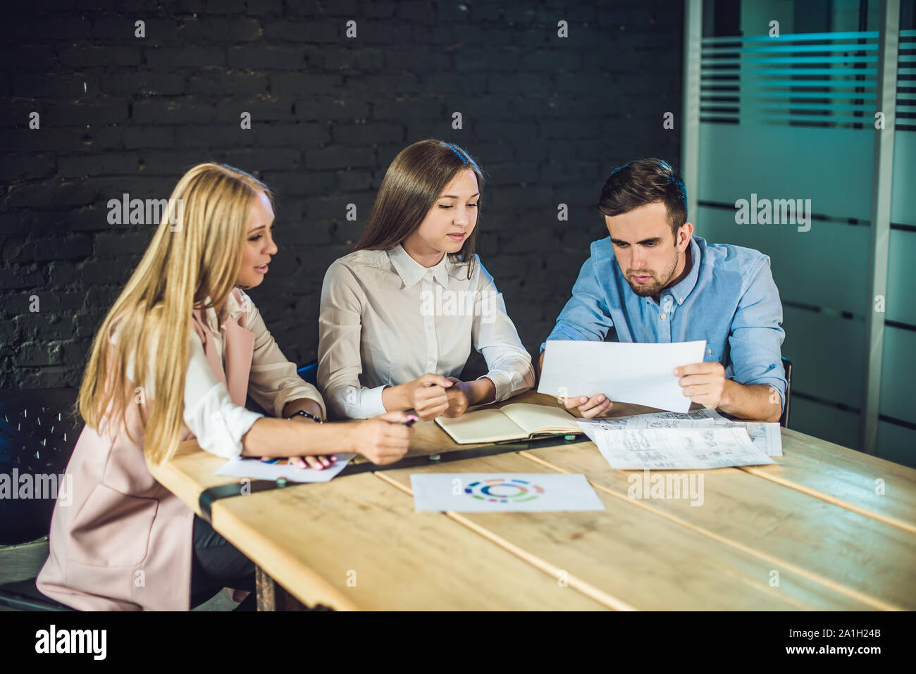 Young team of coworkers watching storyboard for shooting video in ...