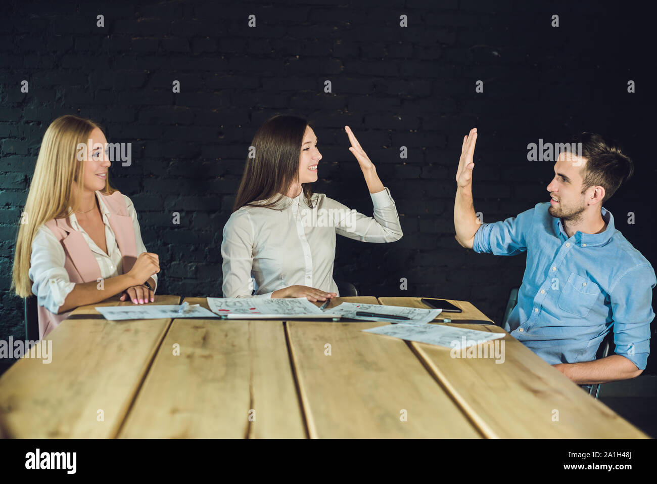 Young team of coworkers watching storyboard for shooting video in ...