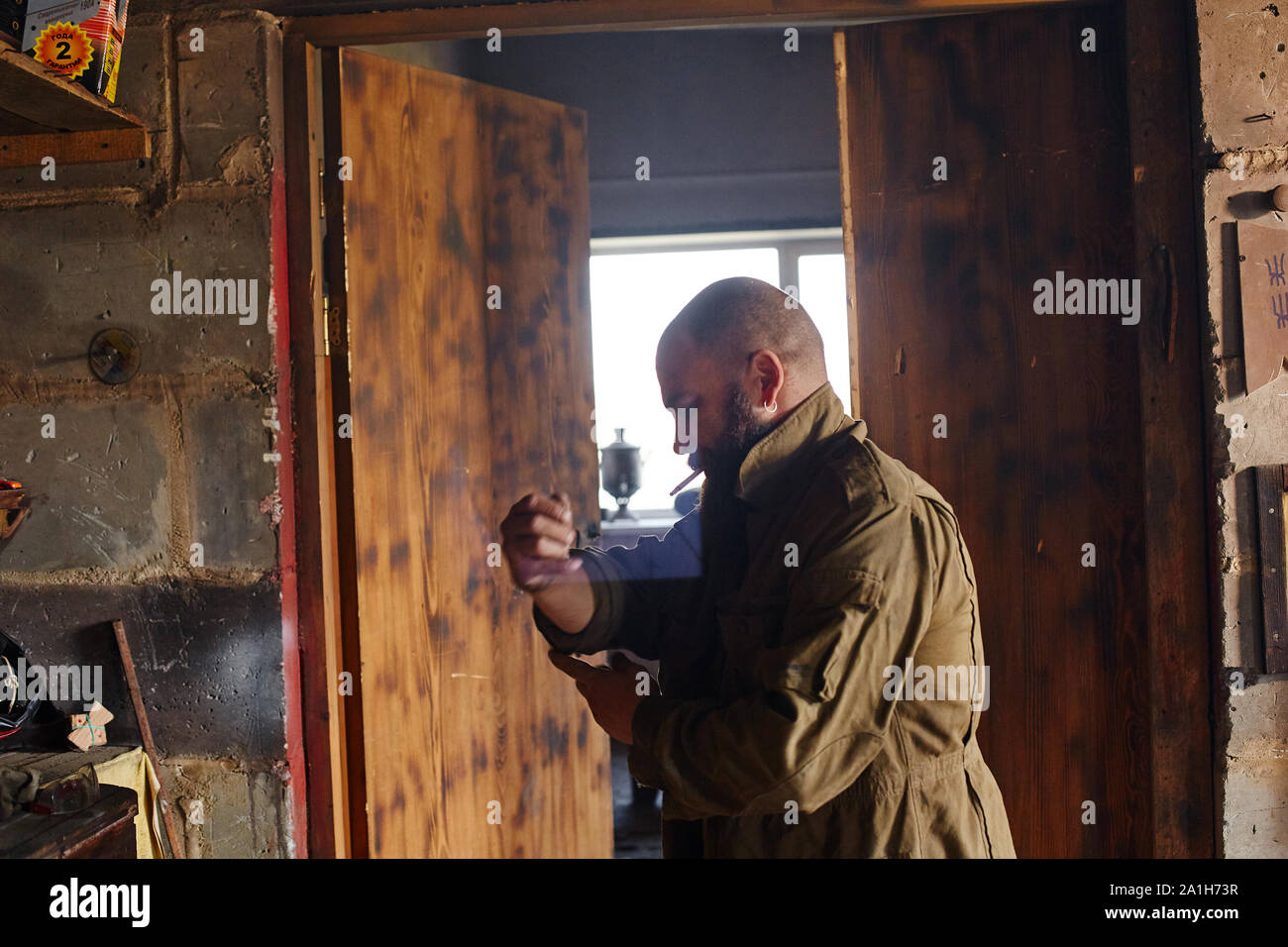 Man's den workshop inside man rolling up sleeves before work Stock ...