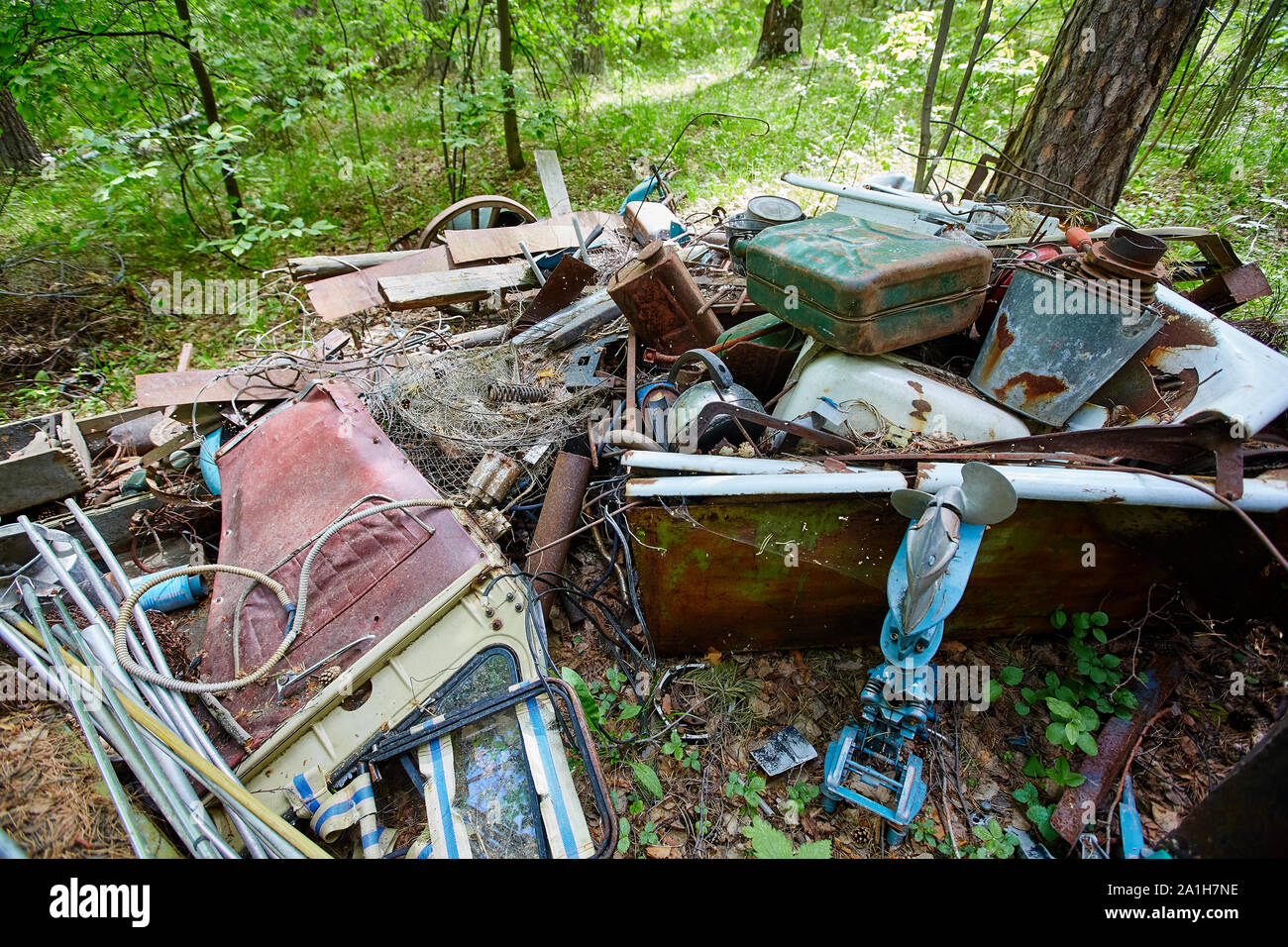 Dump old metal objects in the woods, rusty scrap metal. Environmental ...