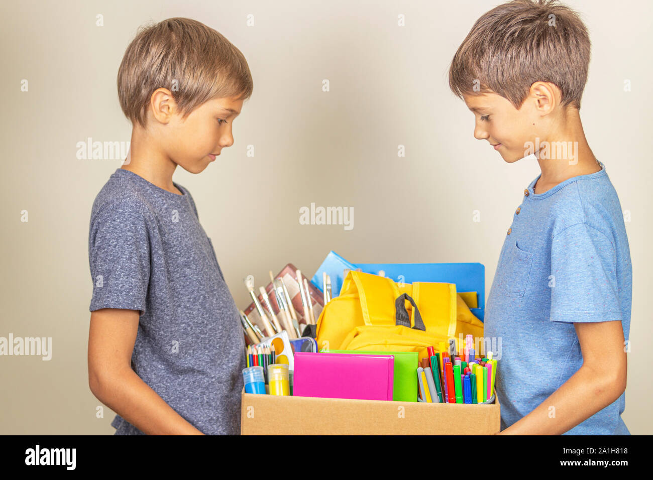 Donation concept. Kids holding donate box with books and school ...