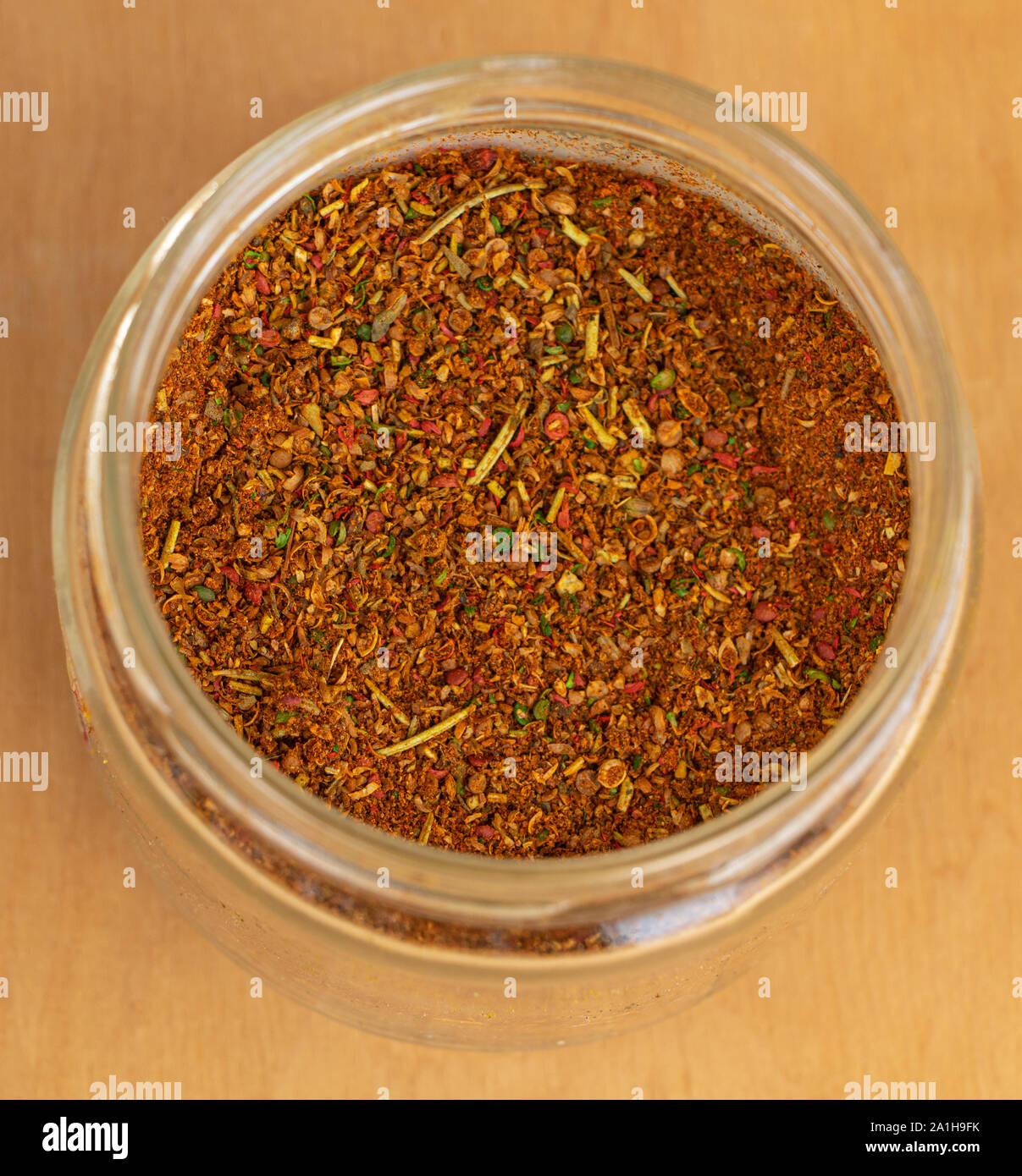 Spice for meat on wooden background in a jar Stock Photo - Alamy