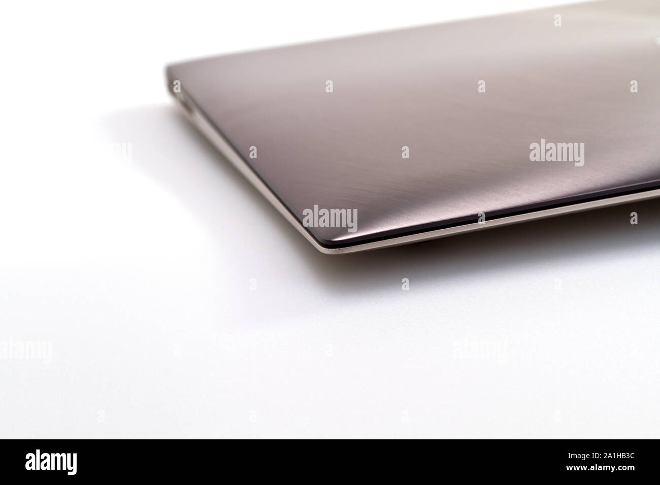 a modern metal laptop with closed lid on white background for abstract ...