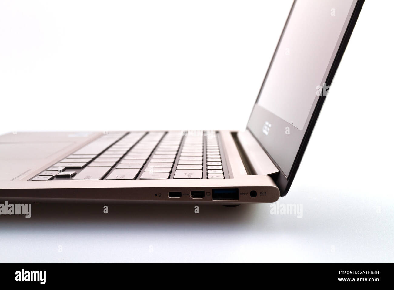 a modern metal laptop with opened lid against white background for ...