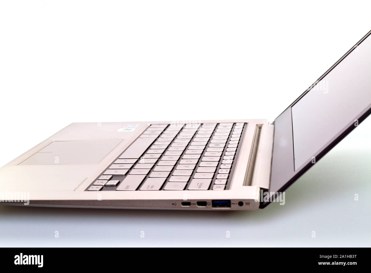 a modern metal-fnished laptop with opened lid against white background ...