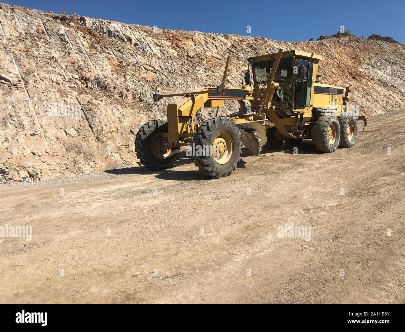 Planning of a road surface. Motor grader during road construction works ...