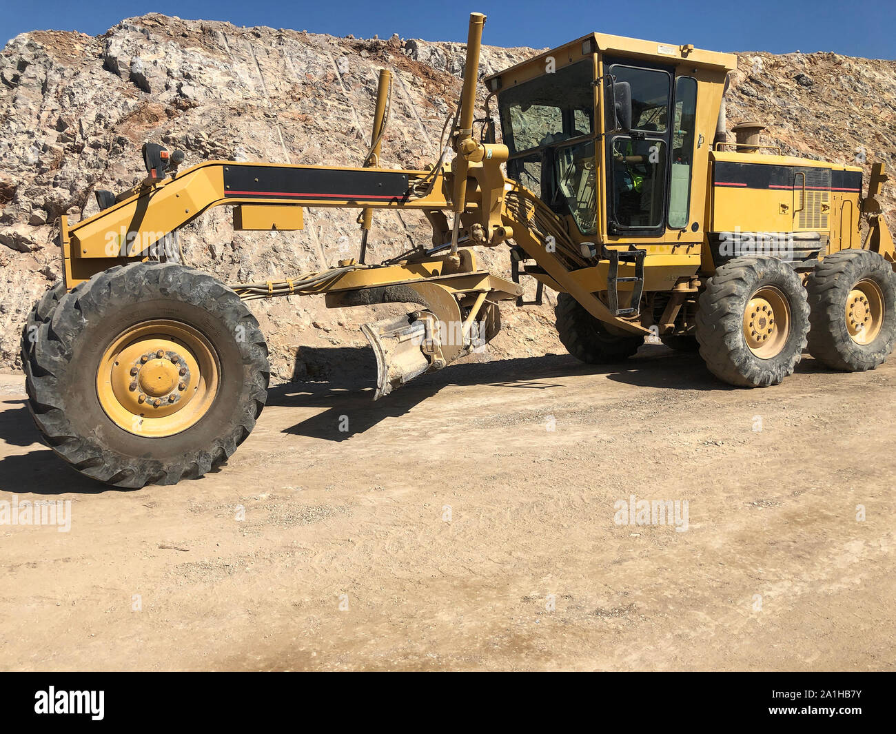 Planning of a road surface. Motor grader during road construction works ...