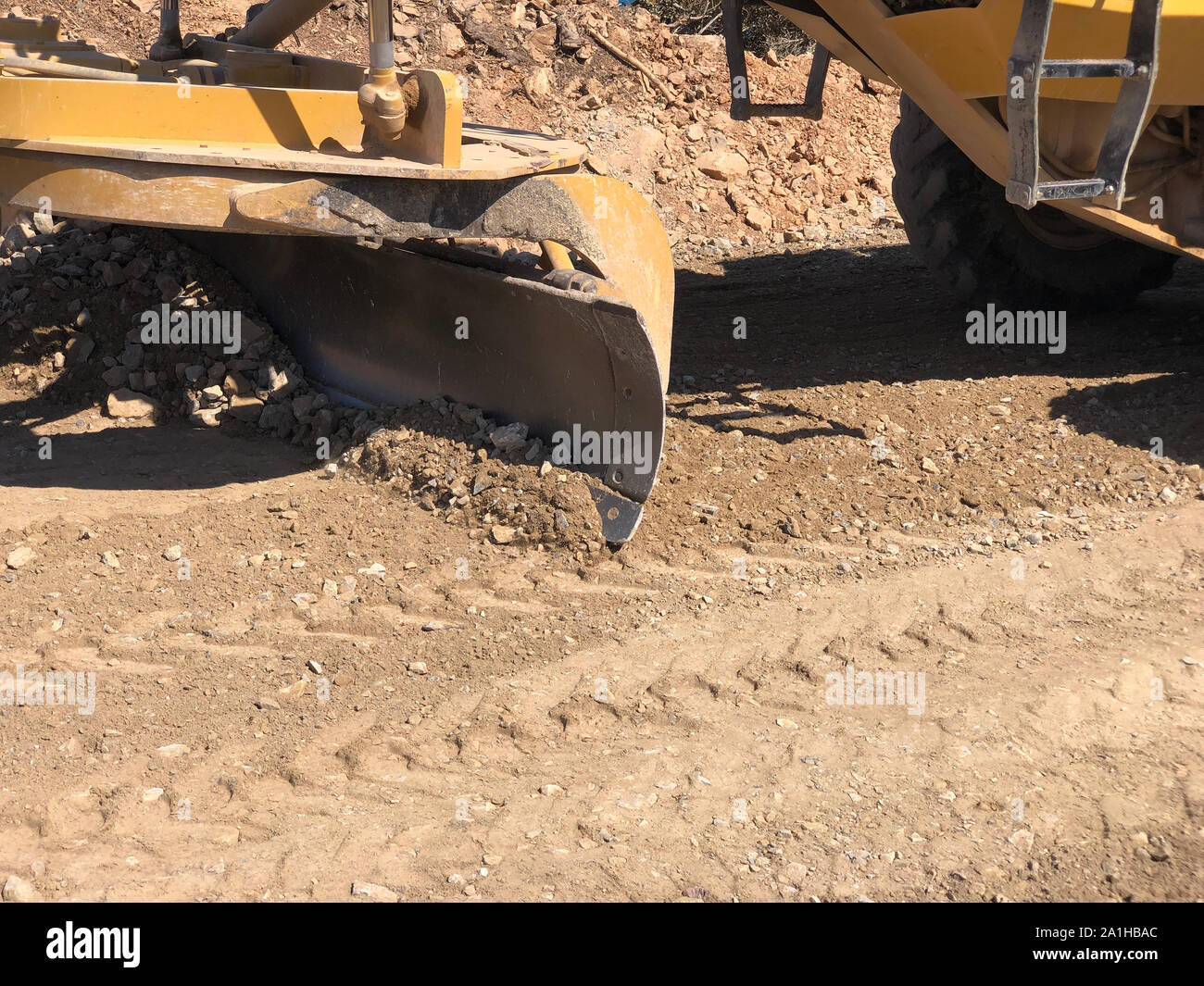 Close-up of moldboard planning road surface. Blade of motor grader ...