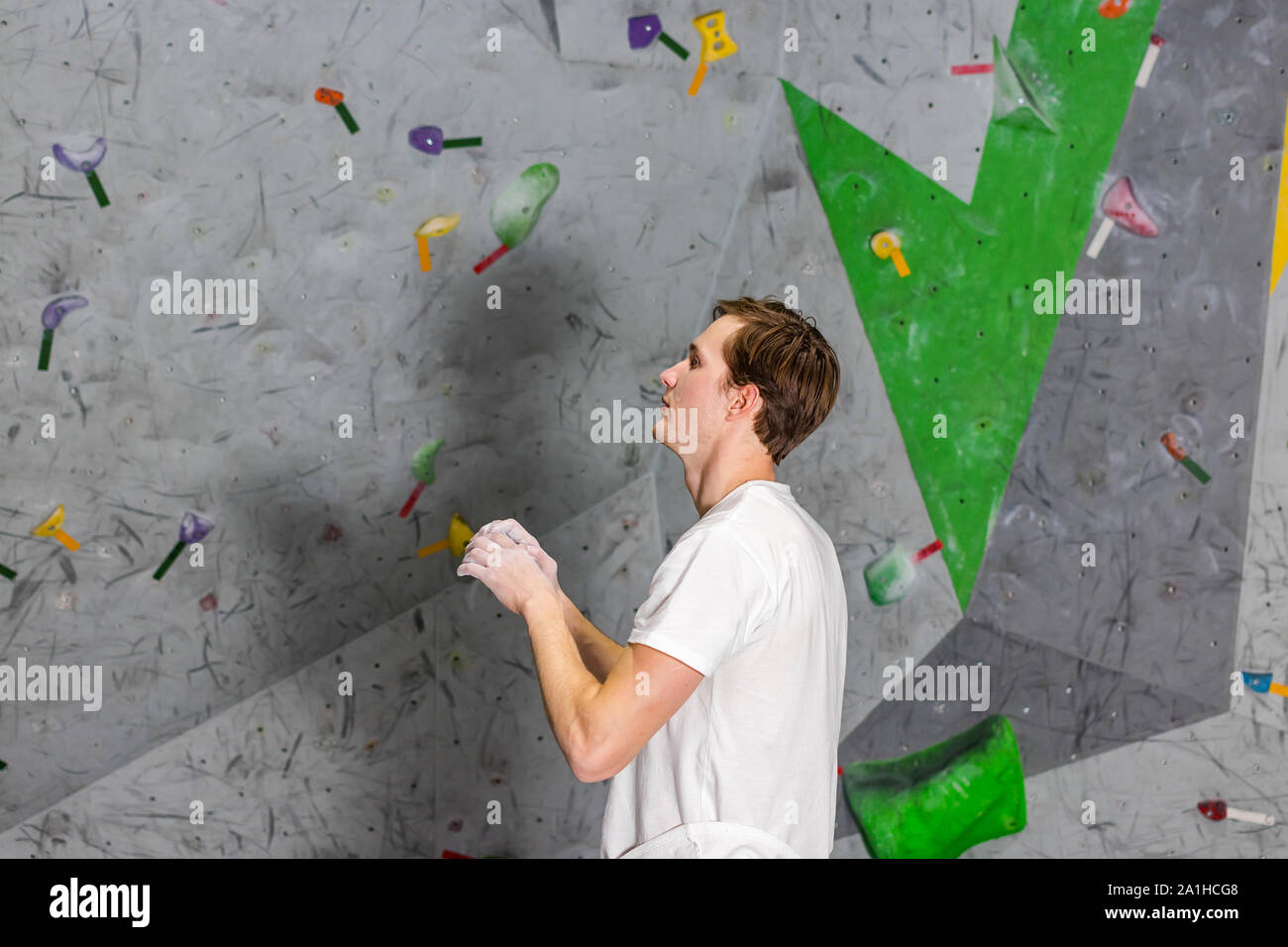 climber explores and develops a route on a climbing wall in the boulder ...