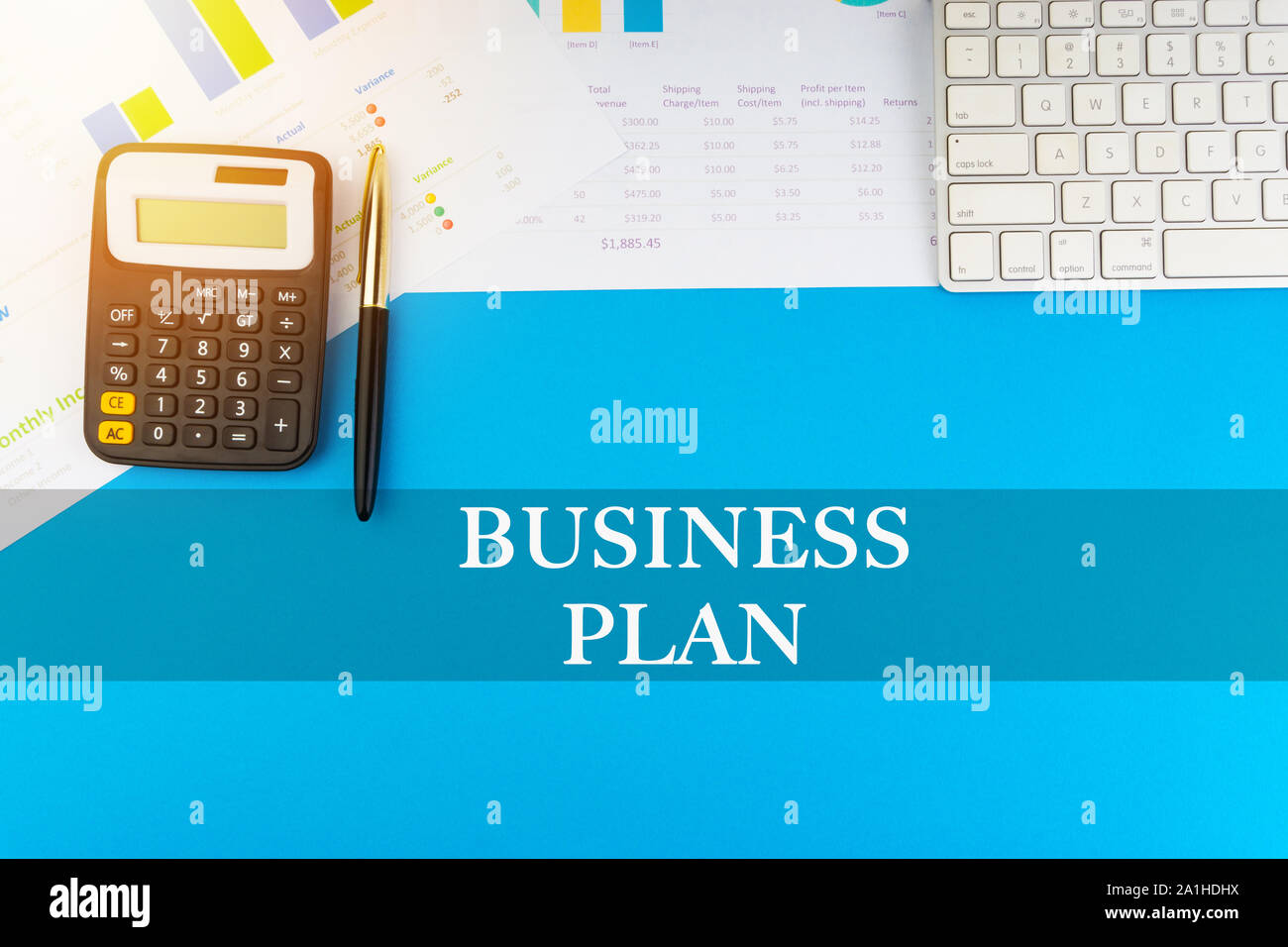 Flat lay view of office workspace with keyboard, pen, paperwork and ...