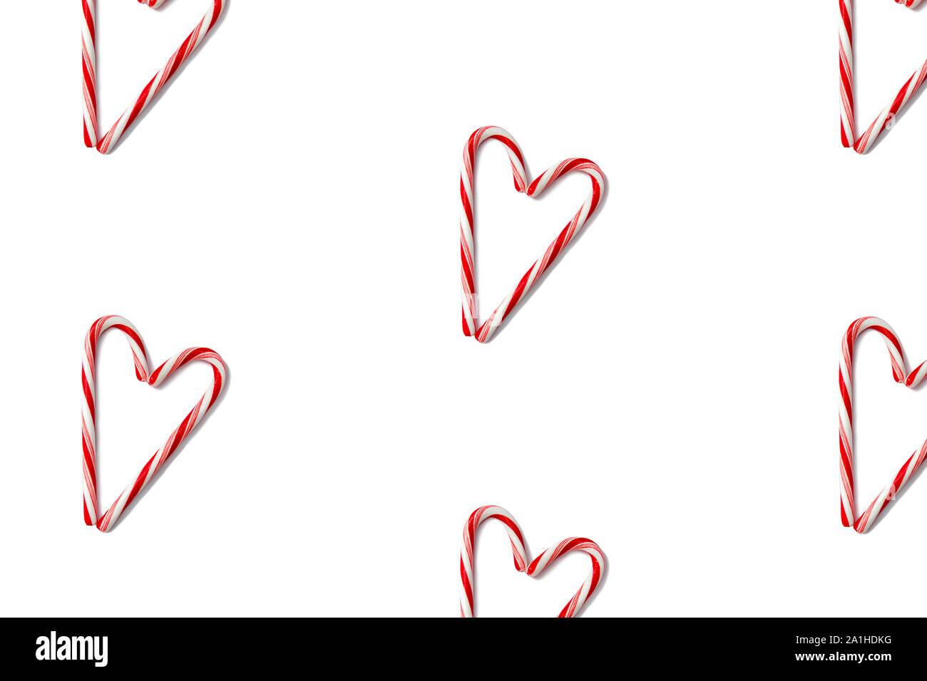 Candy canes shaped heart pattern isolated on white, top view Stock ...