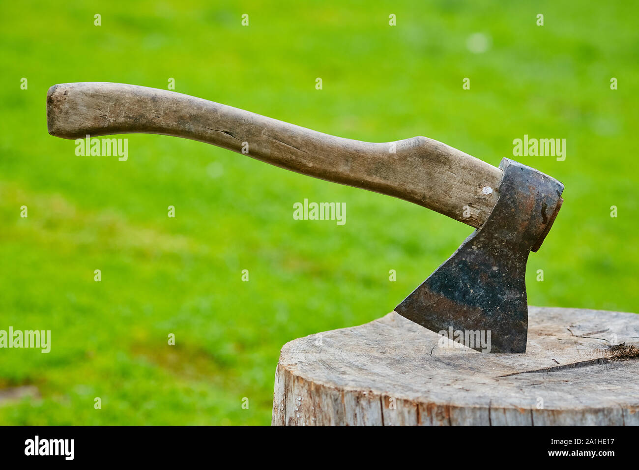 The old axe in the chopping block Stock Photo - Alamy