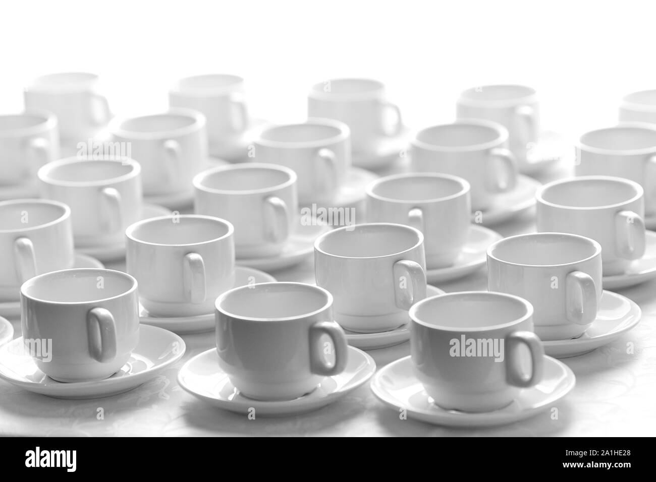 Top view on many stacked in rows of empty clean white cups for tea or ...
