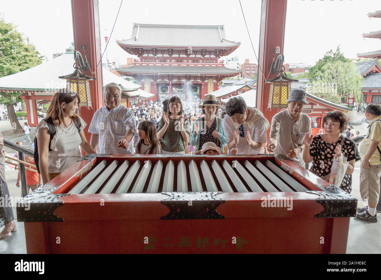 The tourists pray around "saline box" a money offering box outside main ...