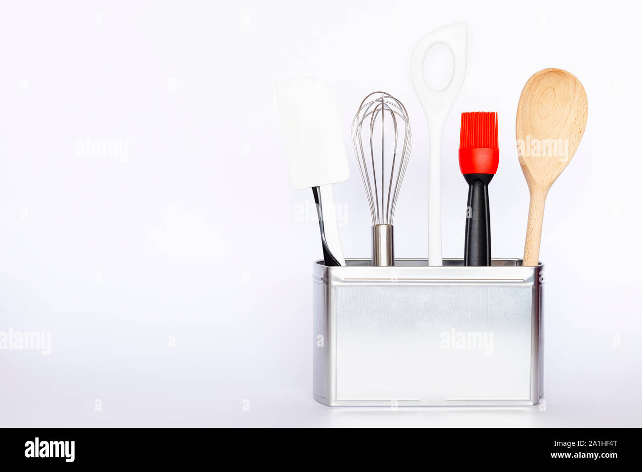 Assortment of kitchenware and cooking tools in a square silver colored ...
