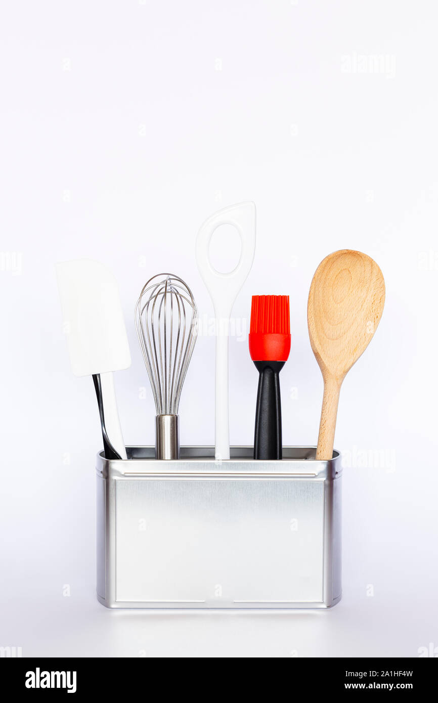 Assortment of kitchenware and cooking tools in a square silver colored ...