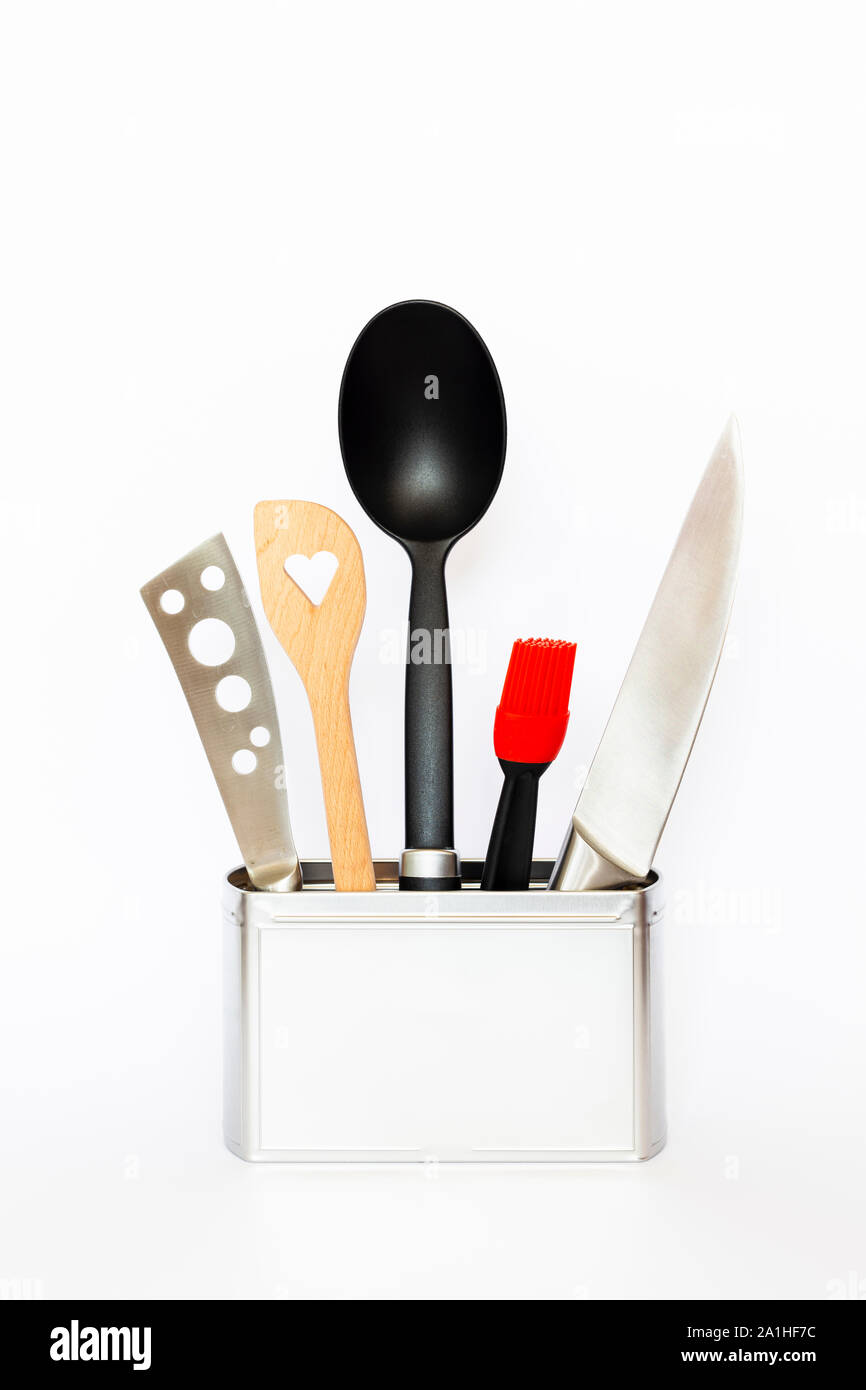 Assortment of kitchenware and cooking tools in a square silver colored ...