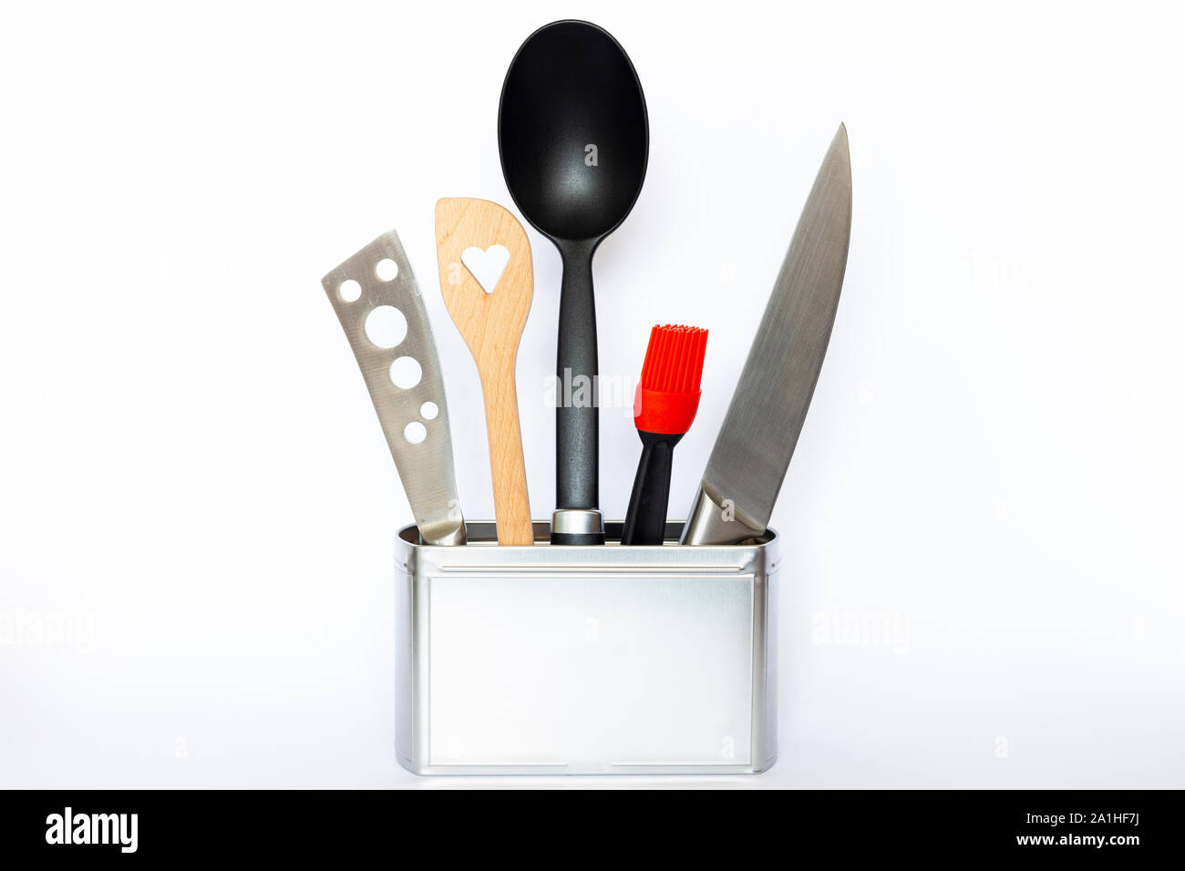 Assortment of kitchenware and cooking tools in a square silver colored ...