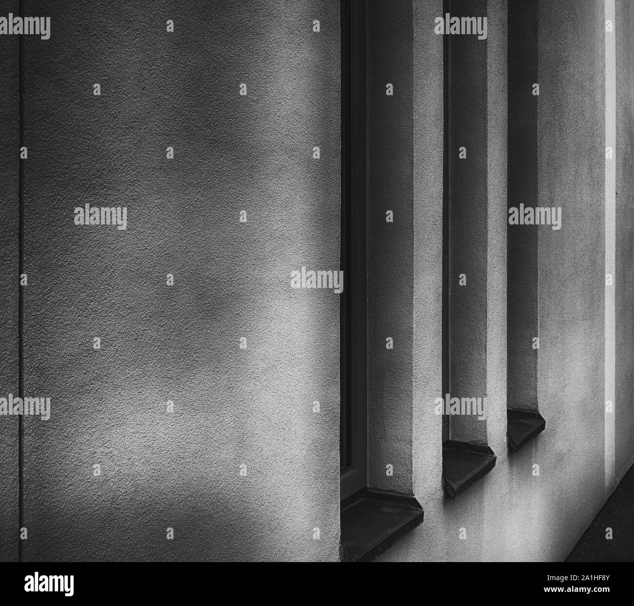 Close view to three slim and high windows combined with other ...