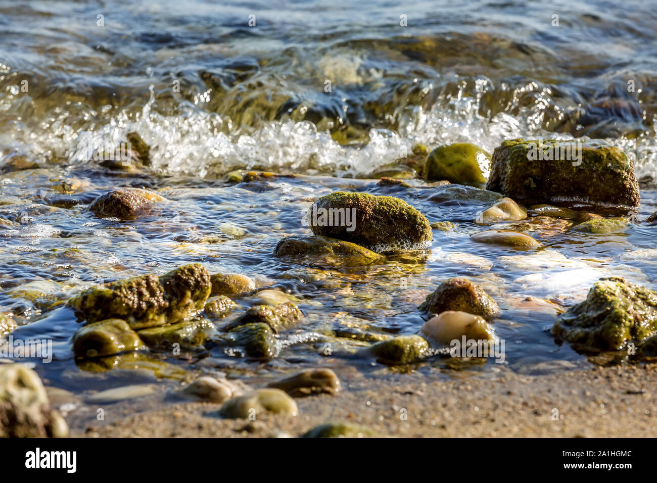 Sea stones background, ocean wave at the beach coast Stock Photo - Alamy