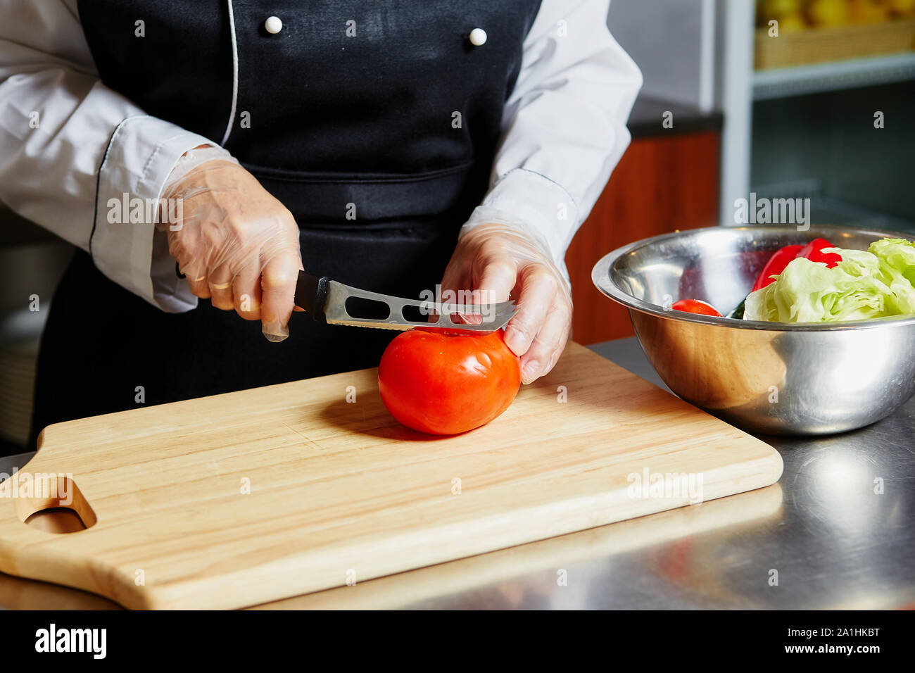 Professional chef cutting tomato hi-res stock photography and images ...