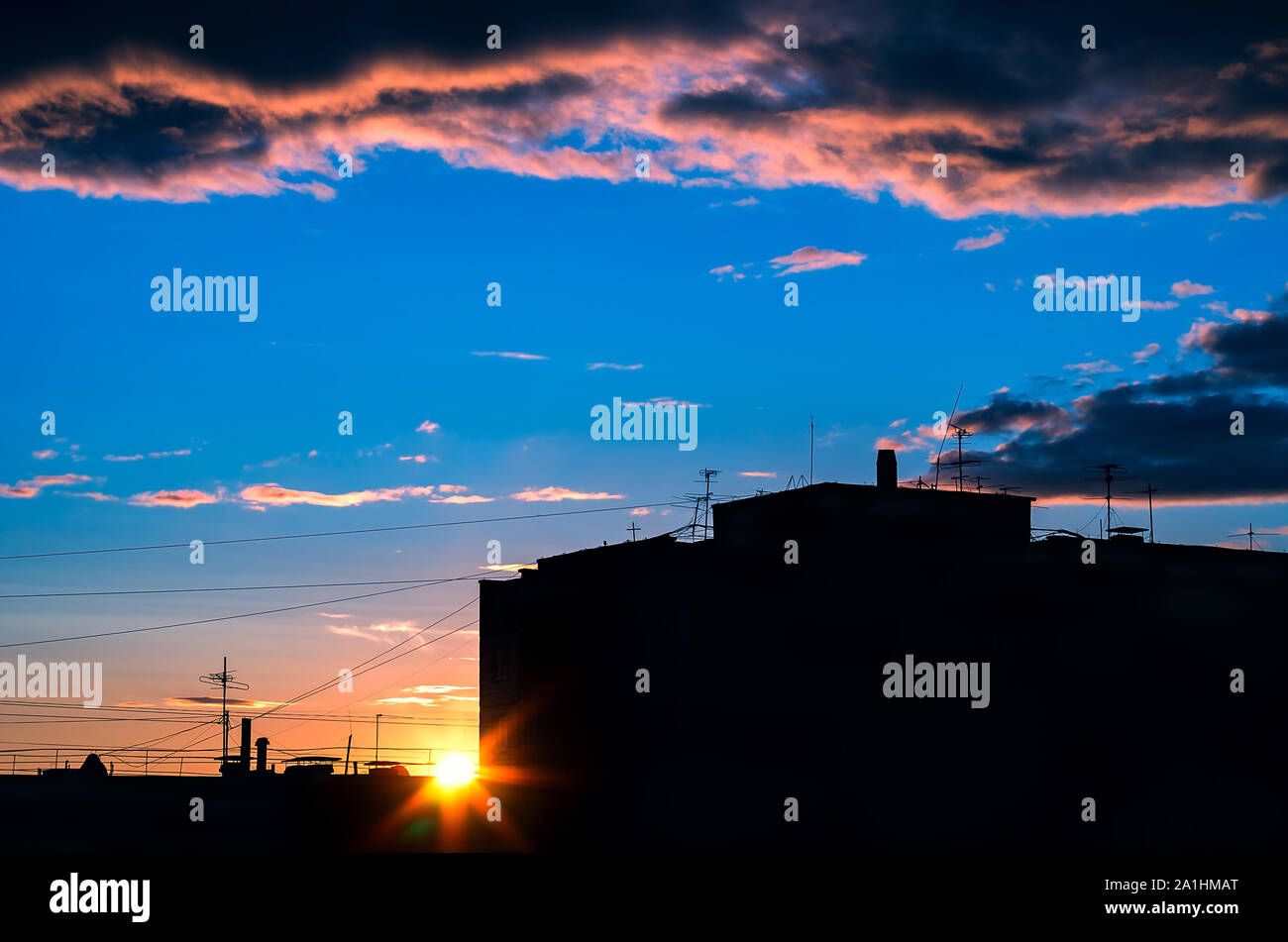 Colorful Sunset over the High-Rise Building Silhouette with Sun Rays ...