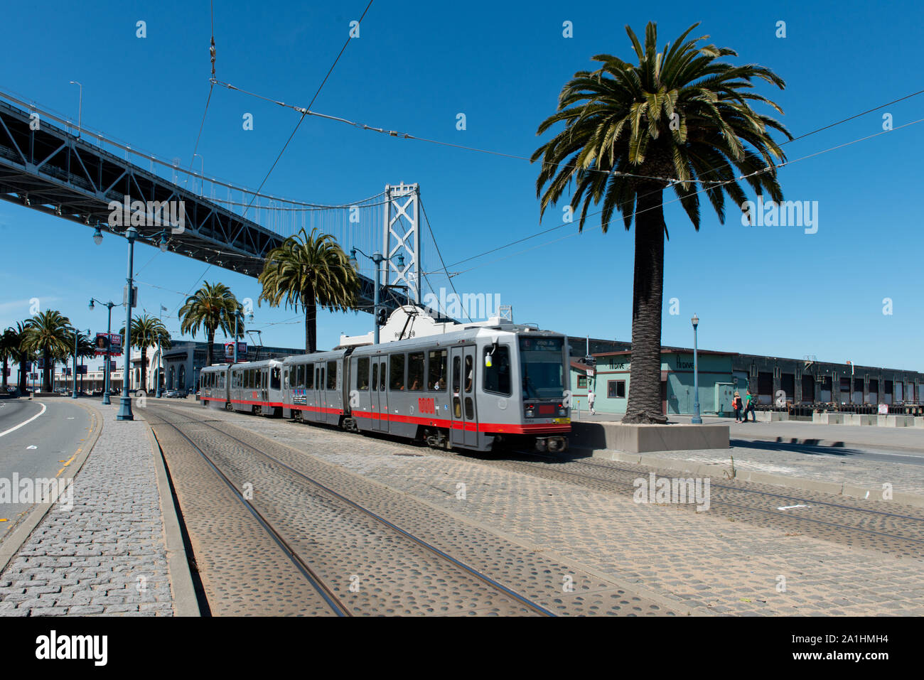 Muni light rail transit car at Embarcadero, with Bay Bridge in ...