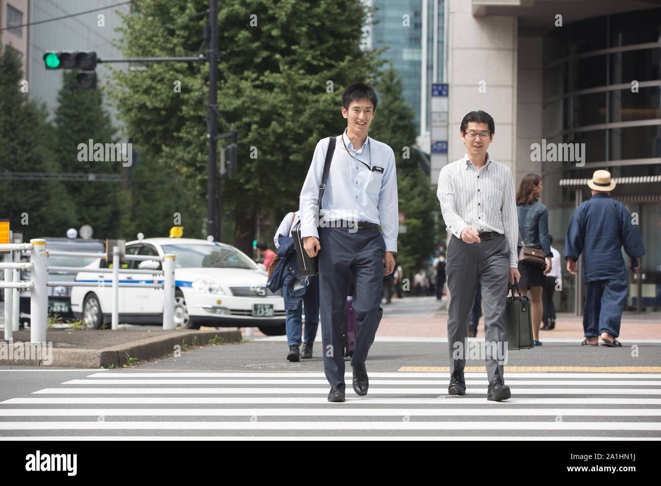 Japanese office workers are crossing an intersection in Chuo City Stock ...