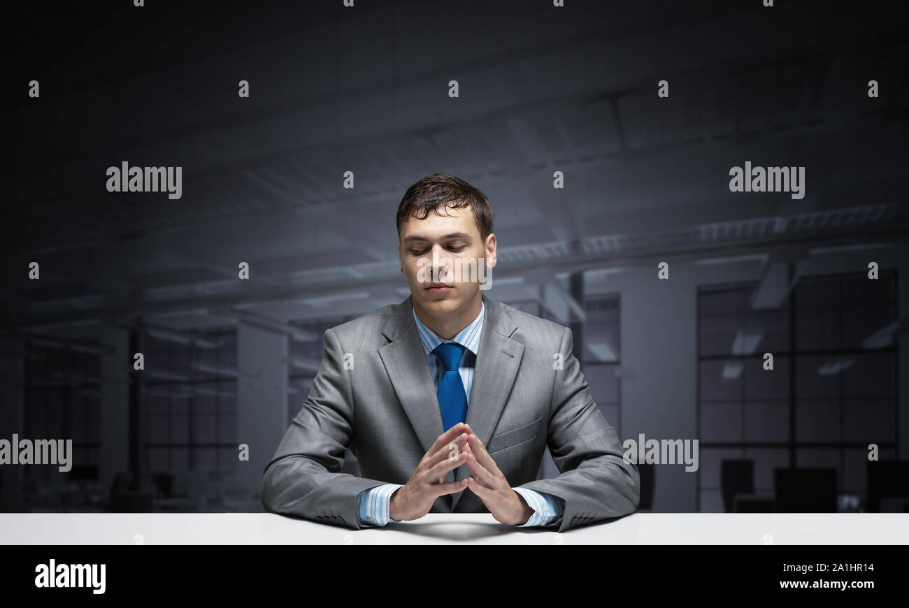 Young man folded hands and having serious and calm face. Businessman ...