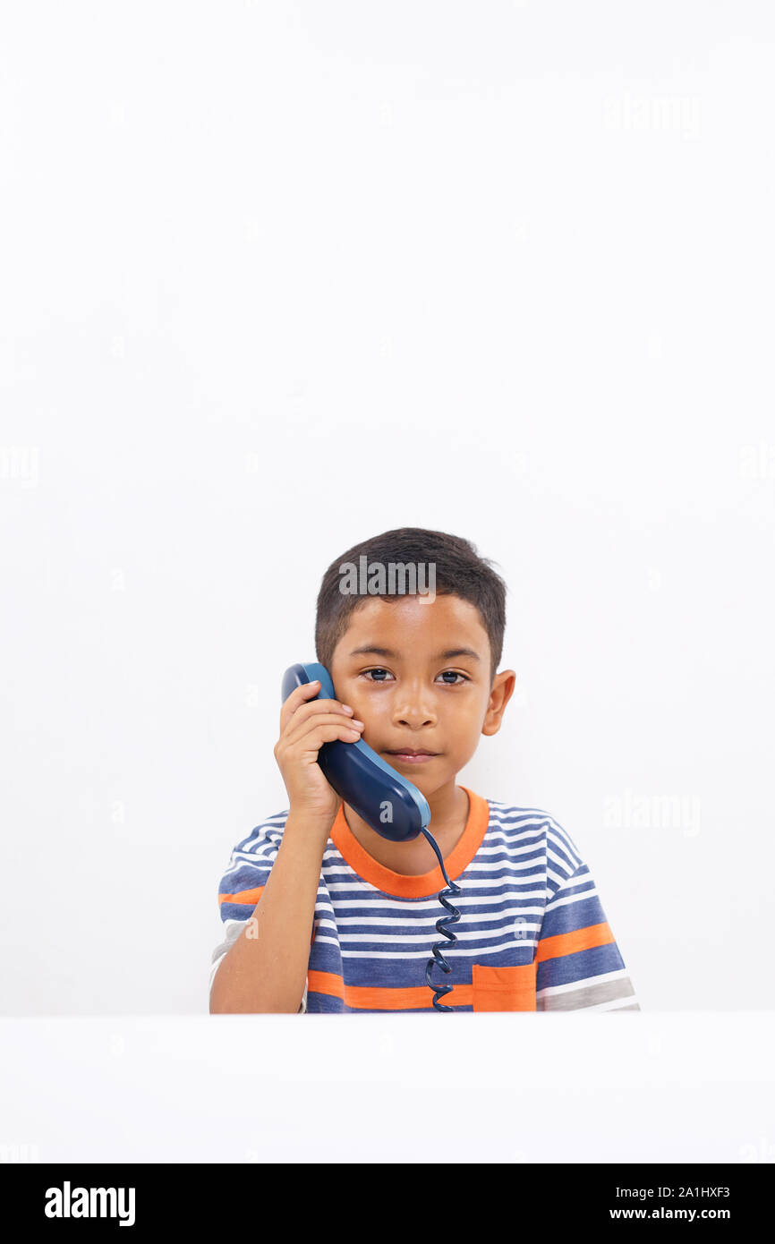 Schoolboy talking with friend using landline telephone Stock Photo - Alamy