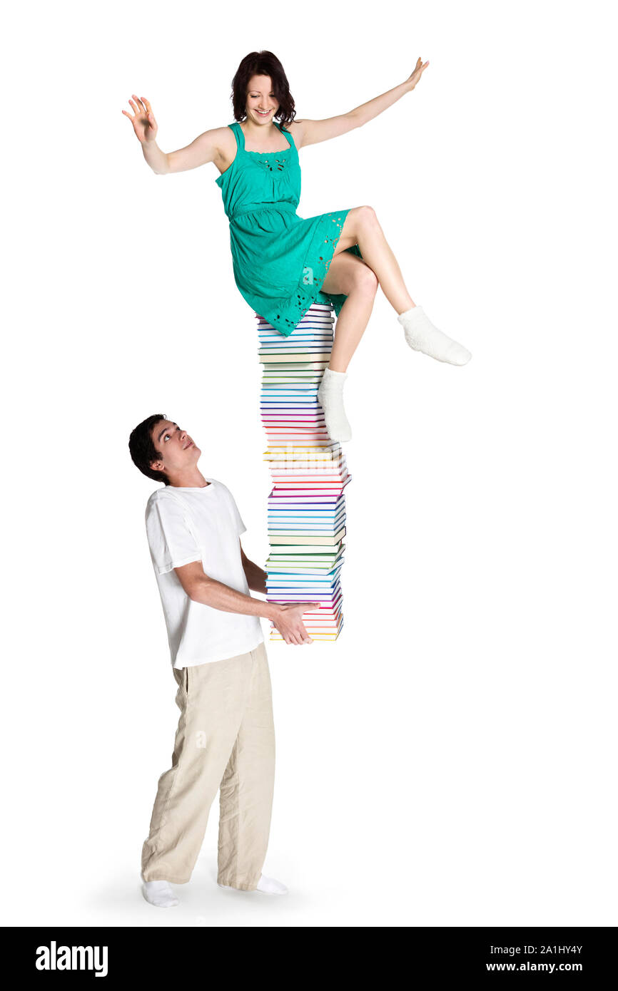 Boy carrying girl on book stack Stock Photo - Alamy