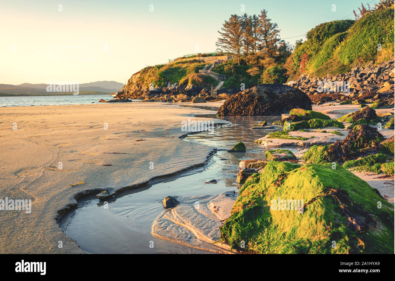 Stream running into the sea at a rocky headland Stock Photo - Alamy
