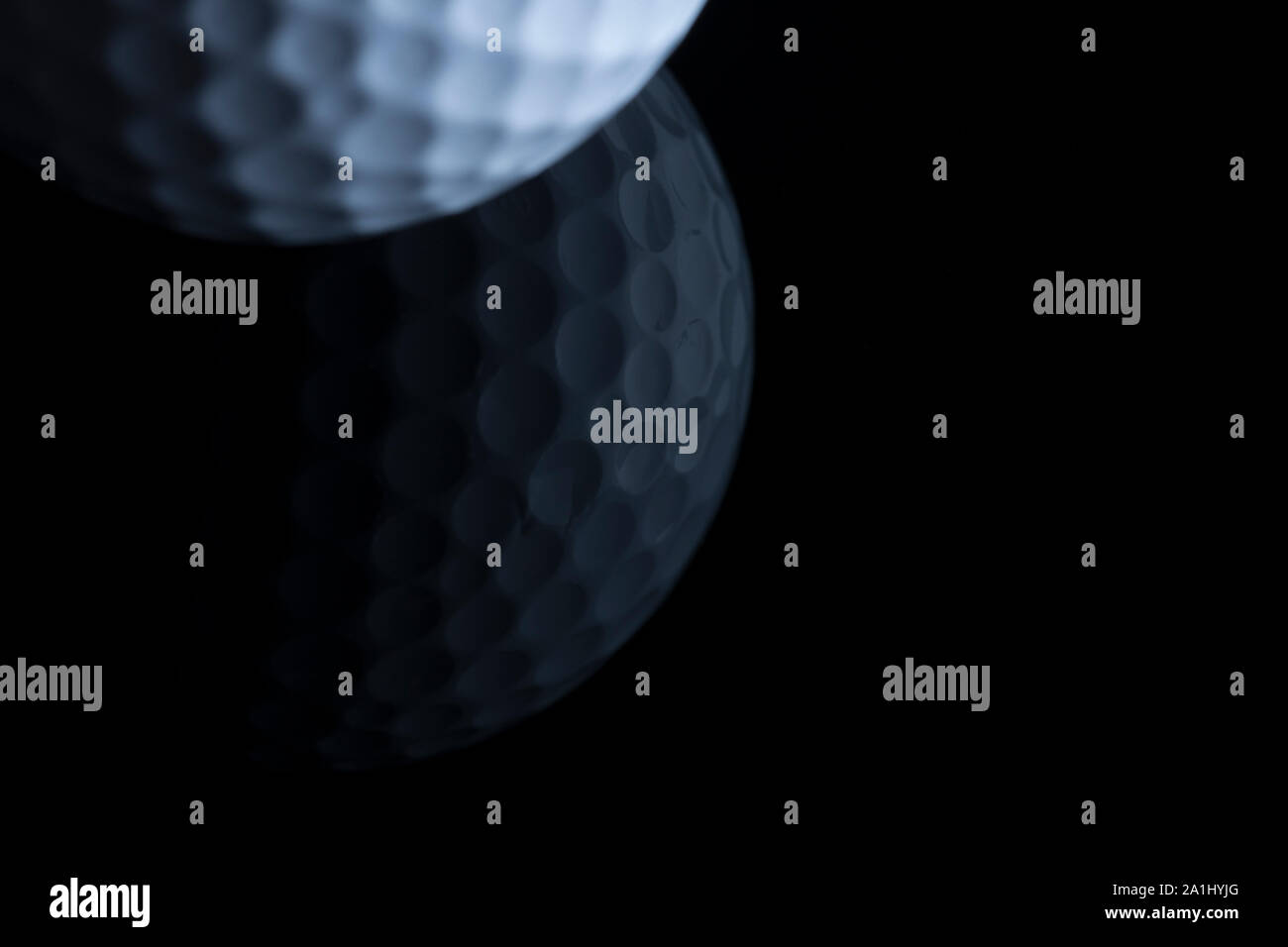 Golf ball with reflection isolated on black background Stock Photo - Alamy