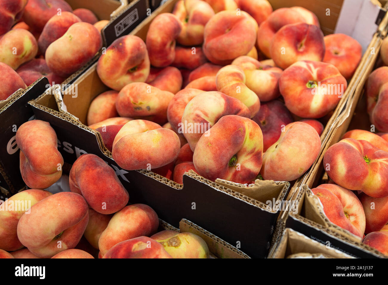Fig peach, flat peaches in paper box at farmer's market or grocery ...