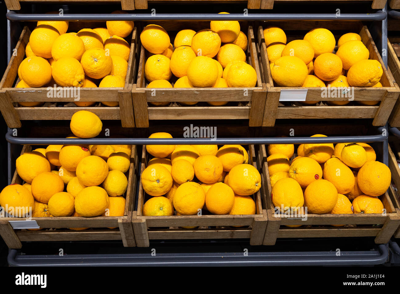 Wooden lug boxes with ripe lemons on counter in supermarket Stock Photo ...