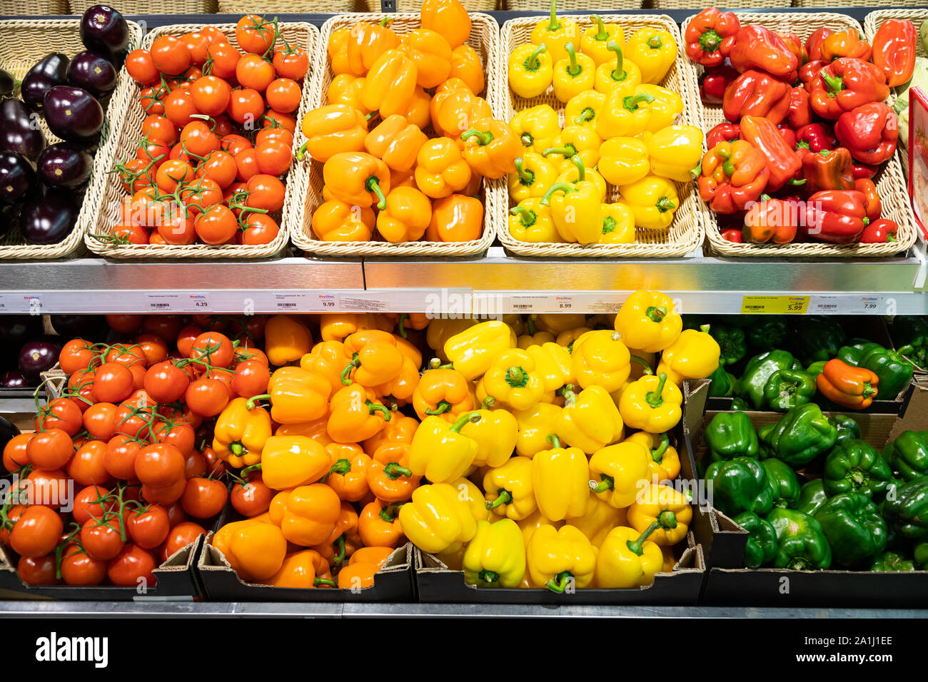 Grocery store counter with wicker baskets and lug boxes with tomatoes ...