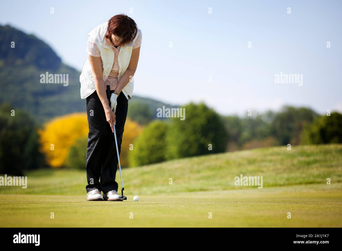 Golf player putting ball Stock Photo - Alamy