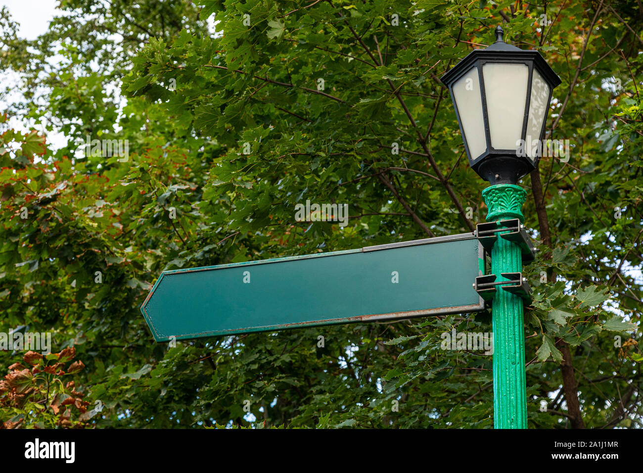 Direction sign on lightpost, classic style Stock Photo - Alamy