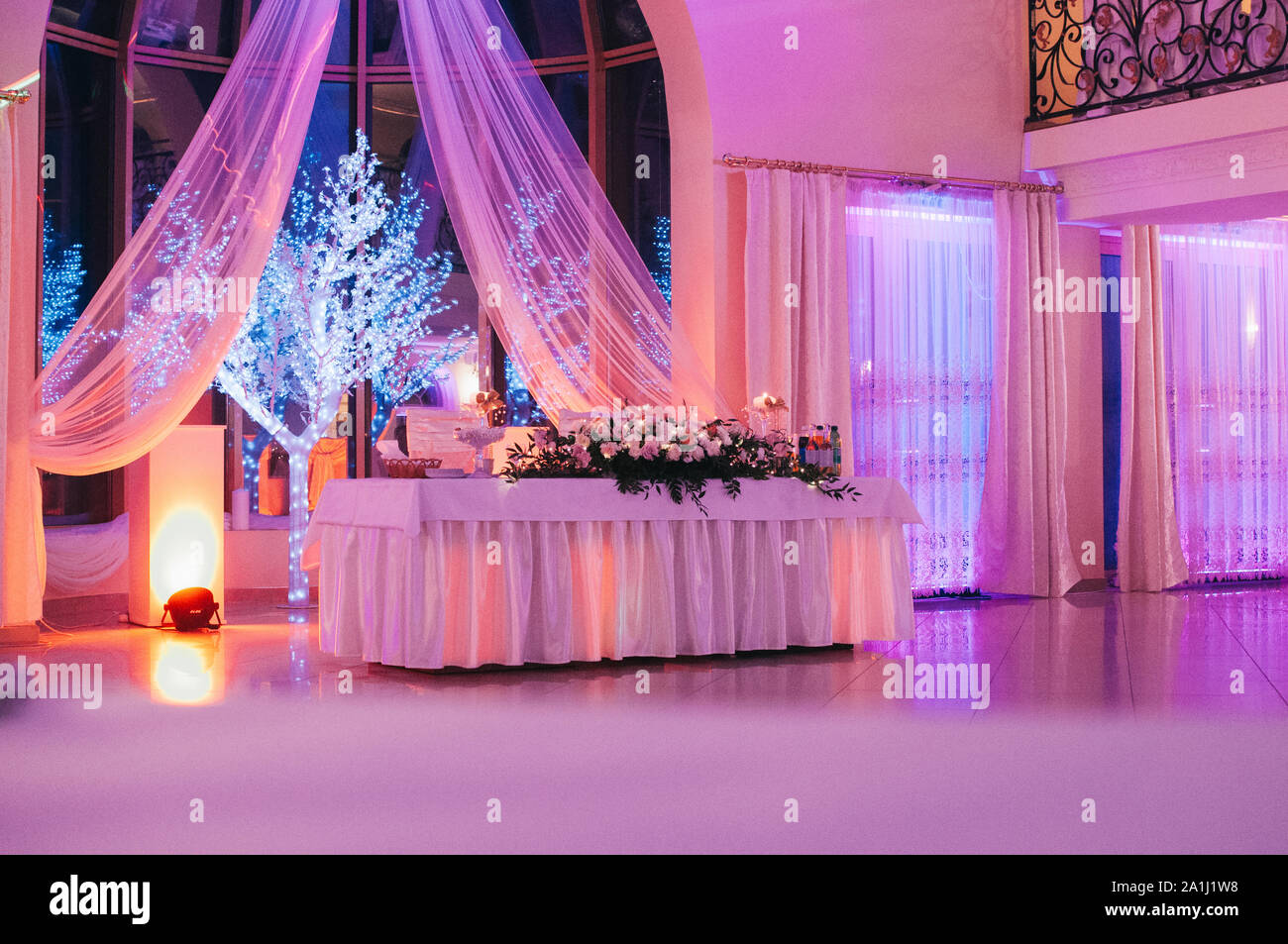 View of moody wedding venue with table, curtains and fairy lights Stock ...