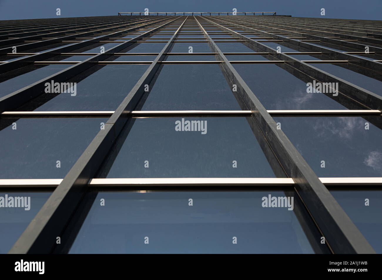 Ground view of skyscraper's wall reflecting sky Stock Photo - Alamy