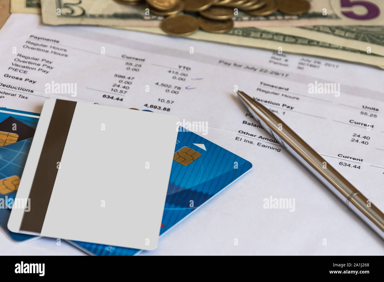 Finance accounting.Paycheck, credit cards, currency top view. Income ...