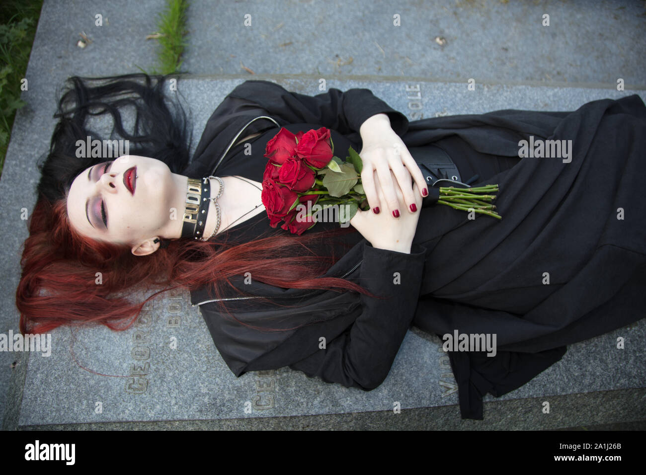 Dark mysterious young female dressed in black goth costume lying on old ...