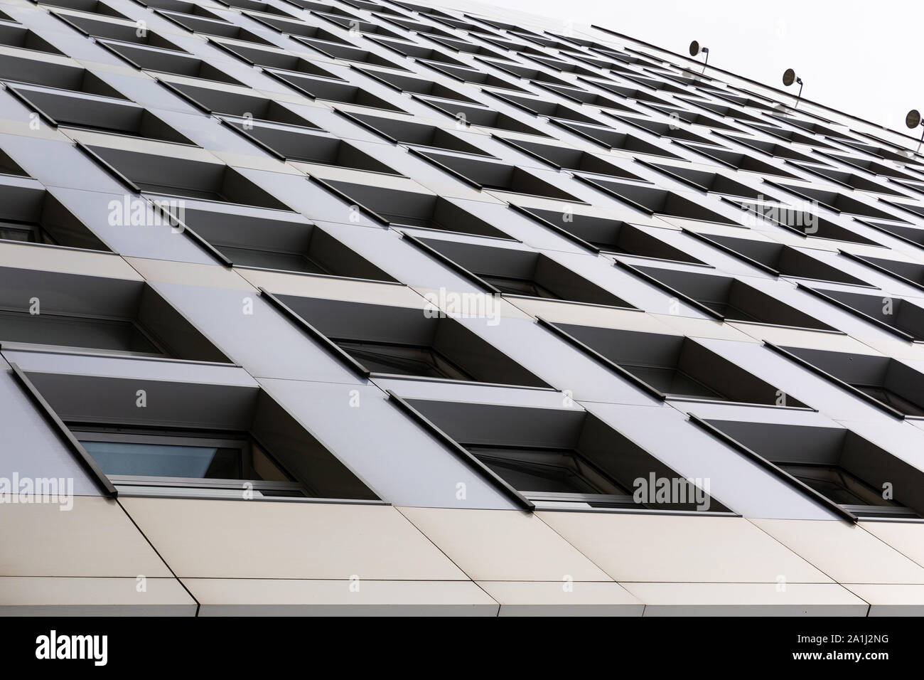 Diagonal view of building surface with lots of windows, ground view ...