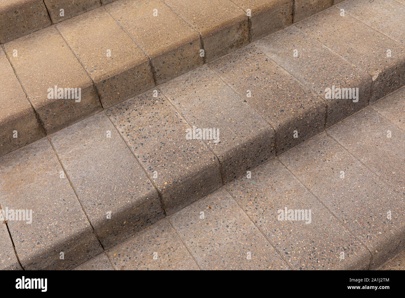 Gray granite brick tiled stairs leading up construction Stock Photo - Alamy