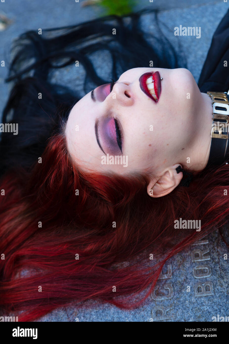 Dark mysterious young female dressed in black goth costume lying on old ...