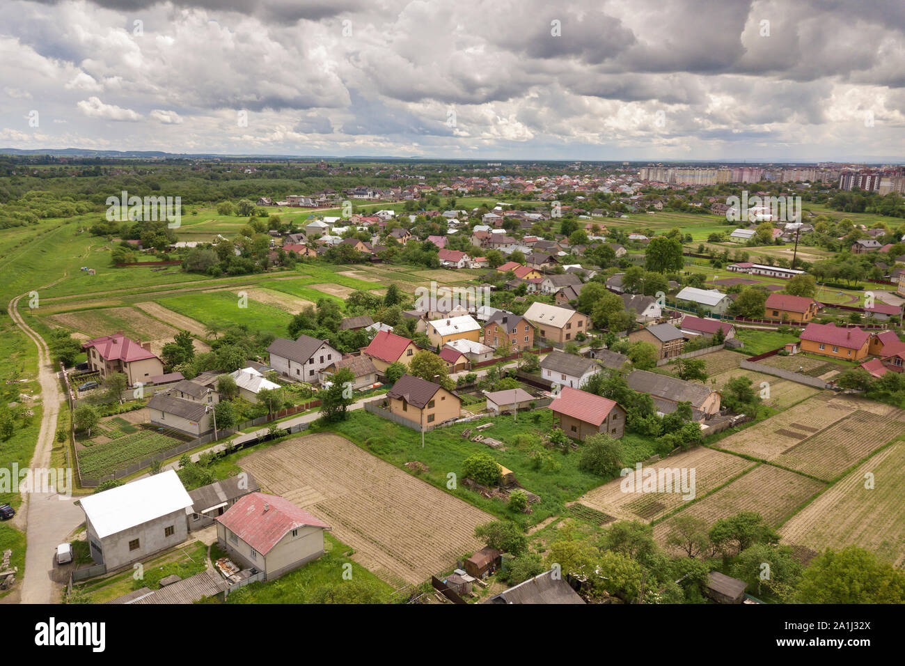 Top down aerial view of town or village with rows of buildings and ...