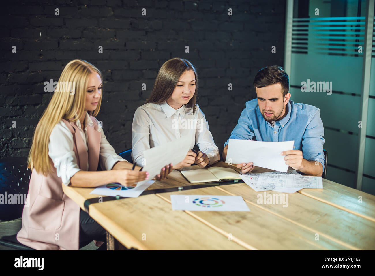 Young team of coworkers watching storyboard for shooting video in ...